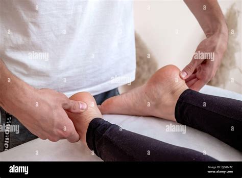 Professional Therapist Giving Traditional Thai Foot And Sole Massage In