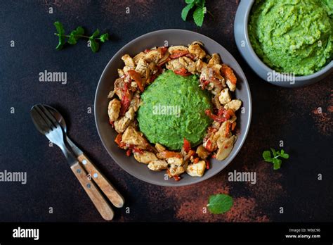 Mashed Potatoes With Green Peas And Corn Served With Chicken And