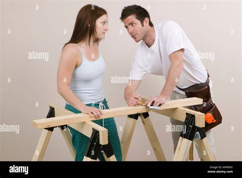 Couple Measuring A Board Stock Photo Alamy