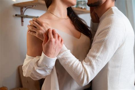 Premium Photo Husband Hugs And Strokes His Wife In The Kitchen Holding Hands
