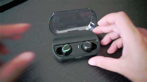 Premium Stock Video Putting In Wireless Bluetooth Earbuds To It S Charging Case And It Starts