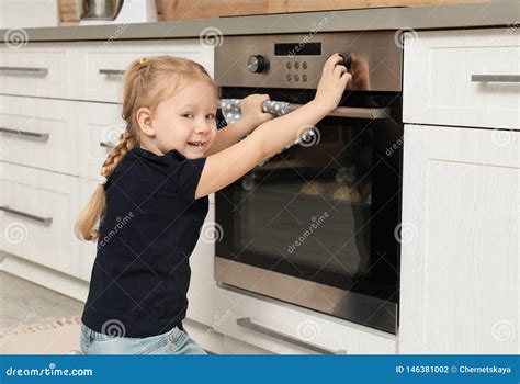 Liten Flicka Som Bakar Kakor I Ugn Arkivfoto Bild Av Kaukasisk Lyckligt 146381002