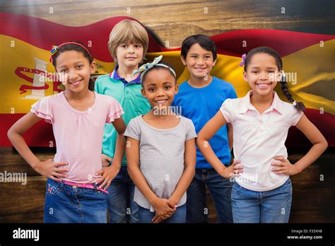 Composite Image Of Cute Pupils Smiling At Camera In Classroom Stock Photo Alamy