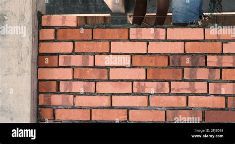 Asian Man Laying Bricks On Top Of Mortar To Build Brick Wall Stock Video Footage Alamy