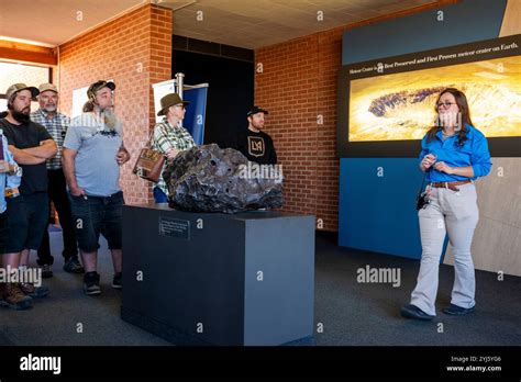 Female Tour Guide Speaking To Visitors Meteor Crater And Barringer Space