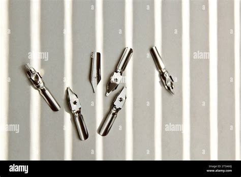 Metal Tips For The Ink Pen On A White Background In Solar Rays Stationery On White Desk Close
