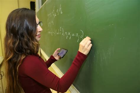Premium Photo Researcher Physicist Calculating On Blackboard