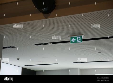 Emergency Exit Sign With Directional Arrow In Modern Building Stock