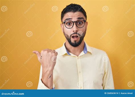 Hispanic Young Man Wearing Business Clothes And Glasses Surprised