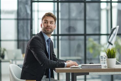 Premium Photo Young Businessman Working At Modern Glass Office