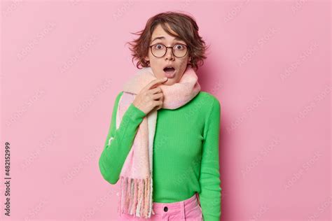 Horizontal Shot Of Impressed Short Haired Young Woman Keeps Mouth