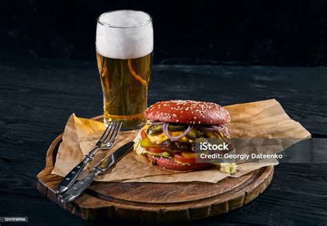 나무 소박한 테이블에 맥주와 감자 튀김 맛있는 햄버거 살롬 양파와 고기 커틀릿을 곁들인 감버거와 거품이 많은 맥주 한 잔 전통 미국 음식 0명에 대한 스톡 사진 및 기타