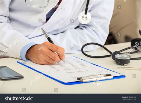 Doctor Filling Medical Form On His Stock Photo Shutterstock