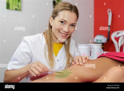 beautician shaving womans leg and smiling Stock Photo - Alamy