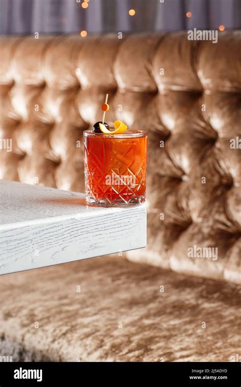 Glass Of Tasty Fresh And Strong Whiskey Cocktail Decorated With Orange