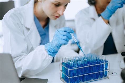 Scientist Team Meeting And Writing Analysis Results In The Laboratory