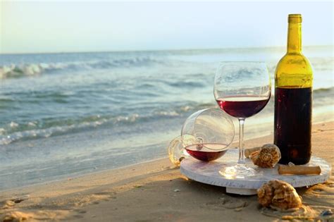 Premium Photo Wine Bottle And Glasses On The Seashore