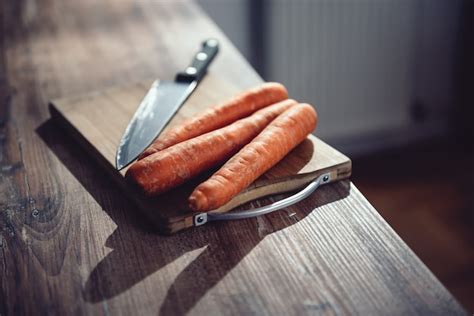 Premium Photo Carrot On Cutting Board