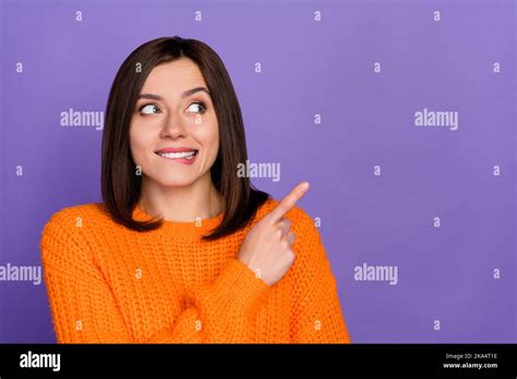 Portrait Of Pretty Positive Girl Biting Lips Look Direct Finger Empty