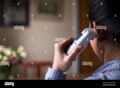 Woman Checking Her Temperature Stock Photo Alamy