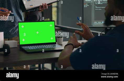 Database Admins Analyzing Source Code And Greenscreen Display On