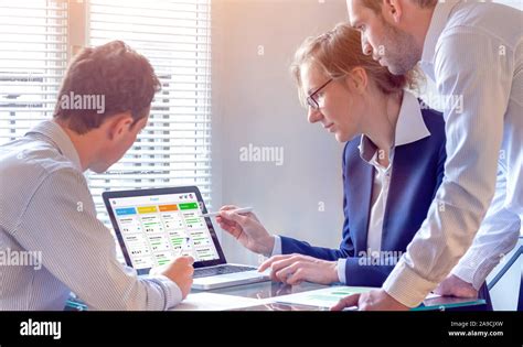 Daily Team Meeting Around Agile Product Development Board With Scrum Or Kanban Framework Lean