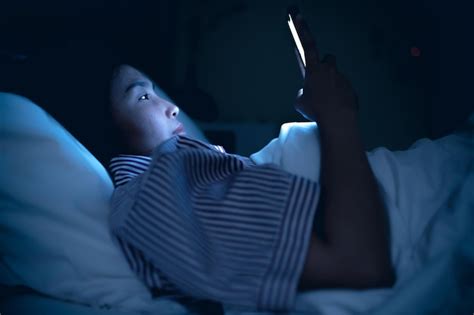 밤에 침대에서 스마트폰으로 게임을 하는 아시아 여성thailand Peopleaddict 소셜 미디어 프리미엄 사진