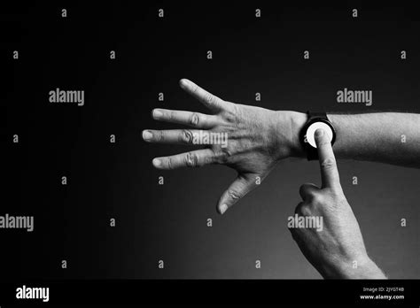 Black And White Image Of Man S Hand With Finger Pressing Smart Watch On Wrist Displaying Blank