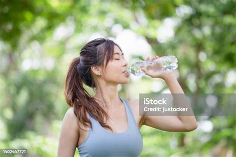 운동 선수 젊은 아름다운 여자 여름 녹색 공원에서 플라스틱 병에서 물을 마시고 운동 후 물을 마시는 스포츠 여성 건강한 생활