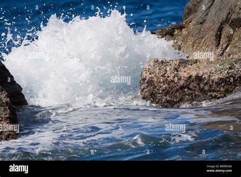 Splash A Wave Splashes As It Hits A Narrow Gap Between Two Rocks On A