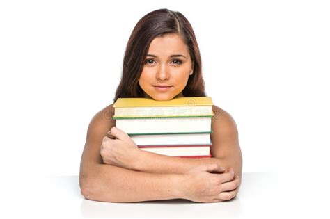 Изображение усмехаясь студента с стогом книг Стоковое Фото