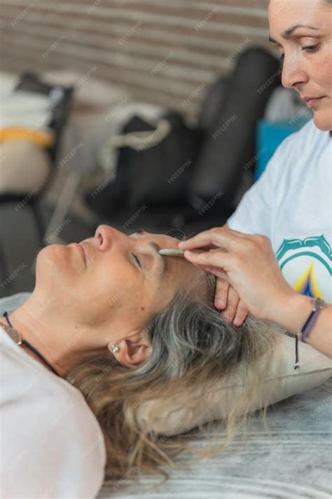 Premium Photo Specialist Giving A Face Massage To An Elderly Woman Lying On The Stretcher