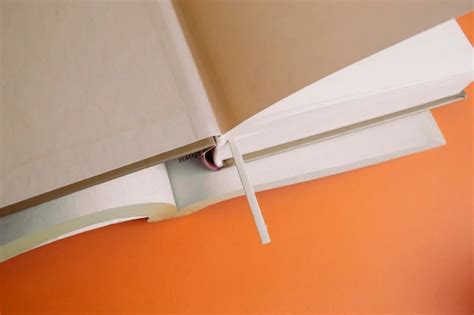 Premium Photo Open Books On An Orange Background There Is A Wooden