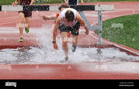 Close Up Of Runners Splashing And Falling In The Water During A Track