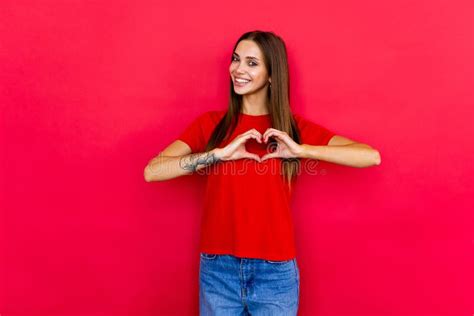 Portrait Of Happy Smiling Girl In Casual Isolated Over Red Background