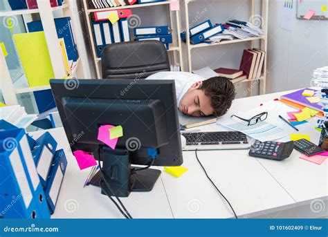 Businessman Working In The Office With Piles Of Books And Papers Stock