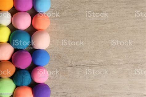 다른 색깔은 나무로 되는 테이블에 반죽 공을 놀고 편평하게 누워 있다 텍스트를 위한 공간 0명에 대한 스톡 사진 및 기타 이미지