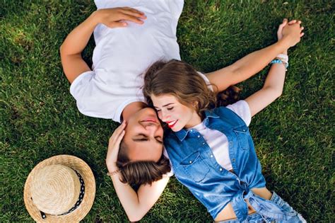 Free Photo Romantic Couple Of Young People Lying On Grass In Park
