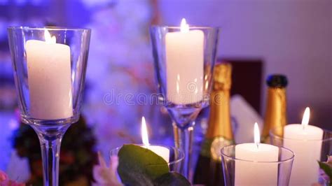 Candles Floating In Glass Vases On Wedding Table In The Evening