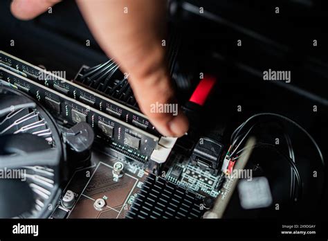 A Close Up Of A Person S Hand Installing Or Adjusting A RAM Module On A Computer Motherboard