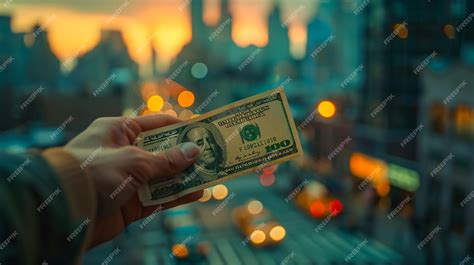 A Person Holding A Dollar Bill That Has The Dollar Bill In The