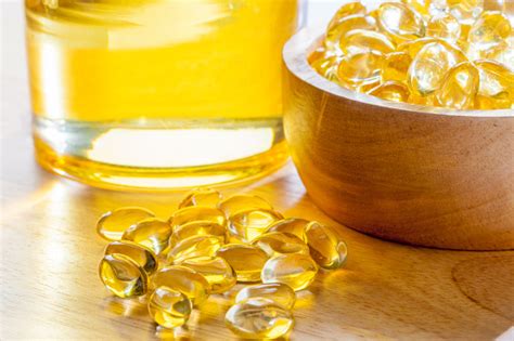 대구 간 기름 또는 나무 배경에 고립 된 나무 그릇에 생선 기름 캡슐 오메가 3 젤 목재 재료에 대한 스톡 사진 및 기타 이미지 목재 재료 보울 비타민 E Istock