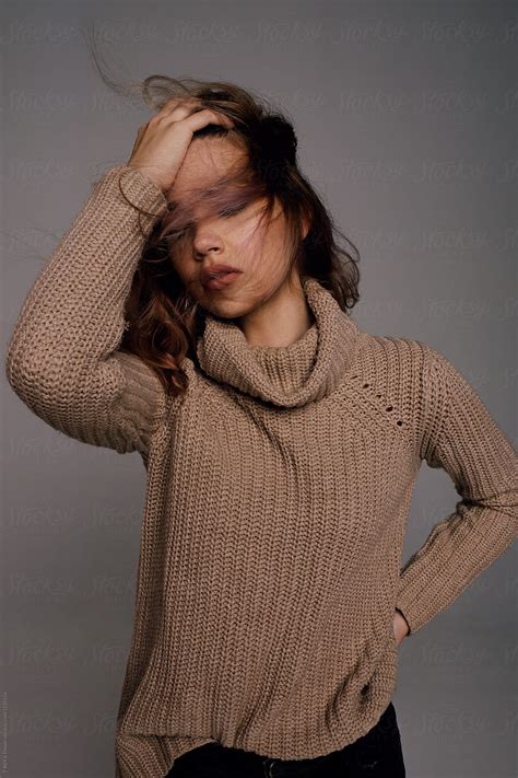 Sensual Young Woman Touching Flying Hair By Stocksy Contributor