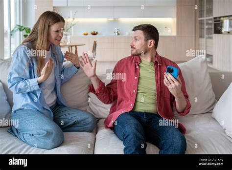 Sly Husband Cheater Hiding Smartphone Display From Unhappy Nervous Reproachful Wife During