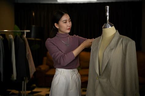 Premium Photo A Female Fashion Designer Measuring Her Suit Model On A Mannequin With Measuring