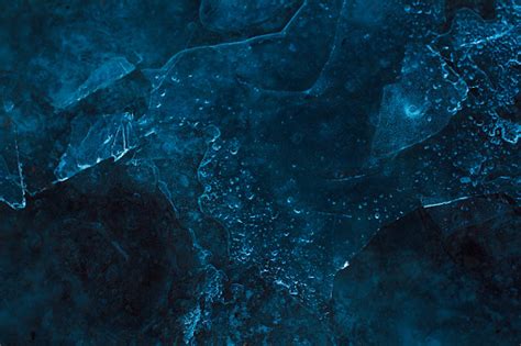 짙은 푸른 색조의 추상적인 얼음 패턴을 클로즈업하여 복잡한 질감과 거품을 보여줍니다 이 이미지는 겨울 자연의 예술성과 얼어붙은 아름다움의 본질을 포착합니다 0명에 대한 스톡
