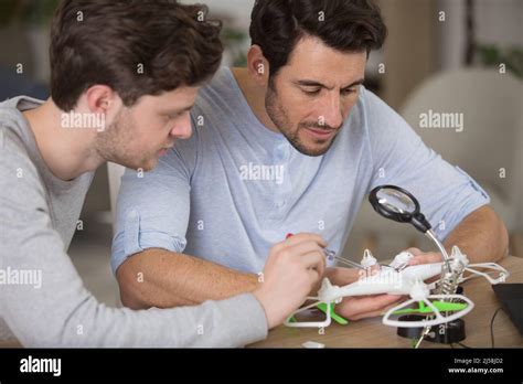 Two Men Assembling The Components Of A Drone Stock Photo Alamy