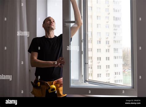 Worker Adjusting Installed Window With Screwdriver Indoors Closeup