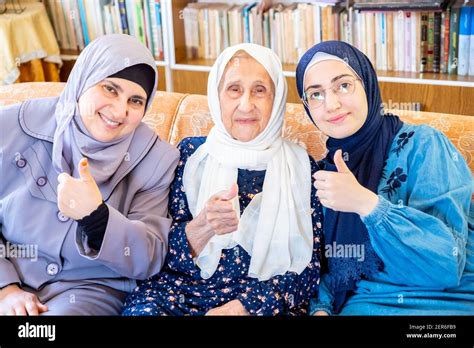 Happy Arabic Muslim Grandmother And Granddaughter And Mother Sitting
