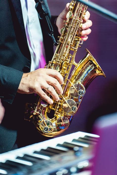 Musical Instrument Saxophone Close Up Hands On A Musical Instrument